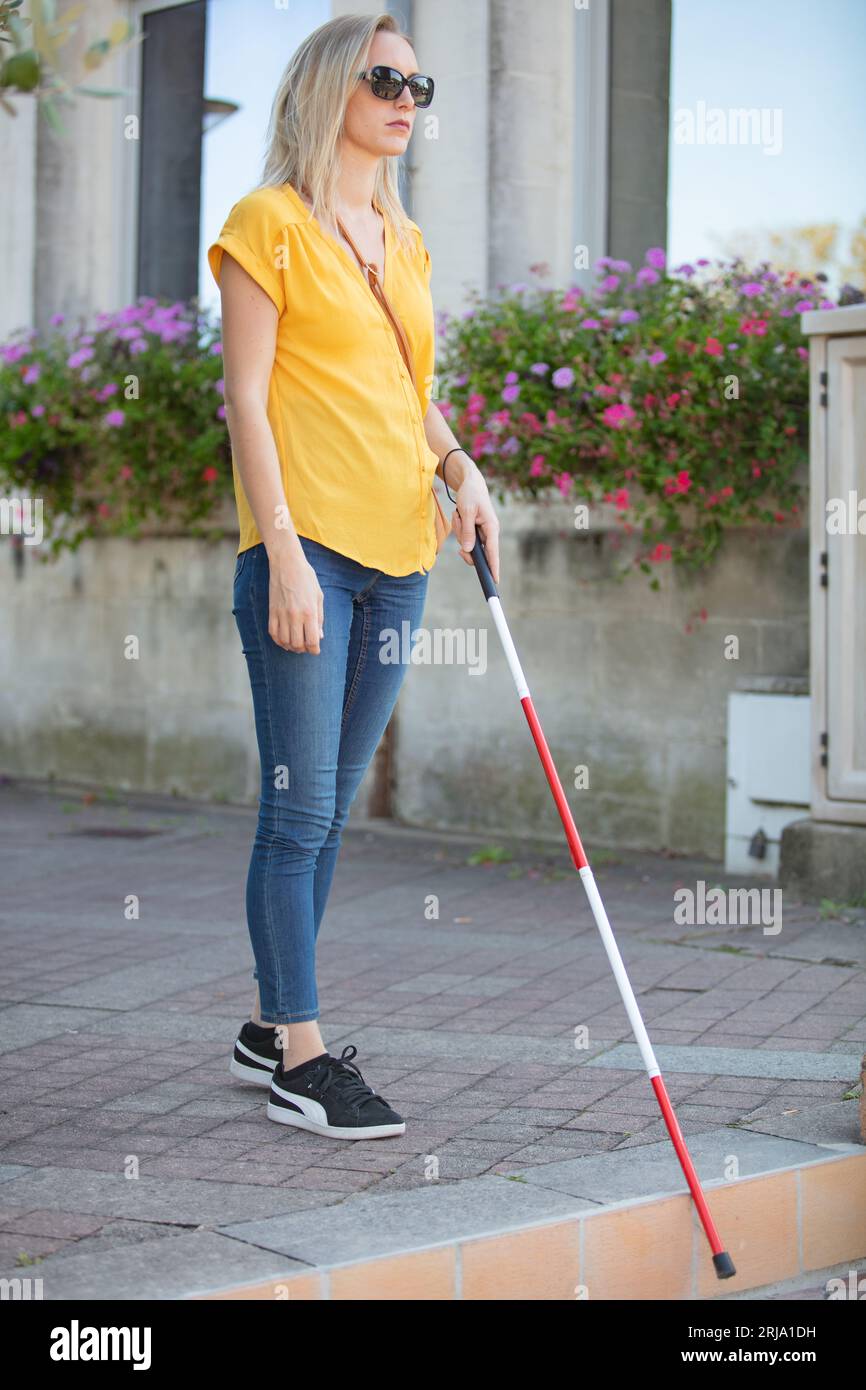 blind woman walking on sidewalk Stock Photo - Alamy