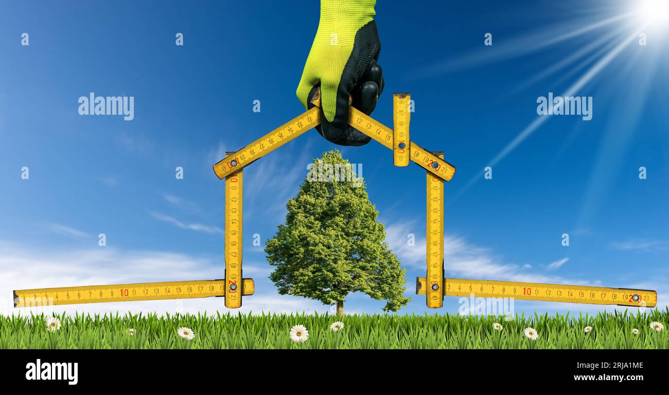 Design or project concept of an ecological house. Gloved hand holding a ...