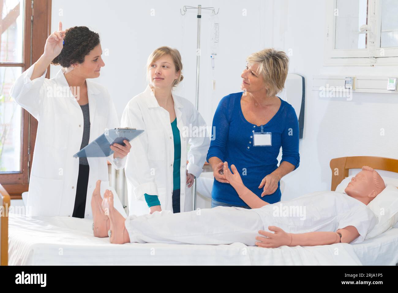 nurse raising hand to ask question during training with mannequin Stock ...