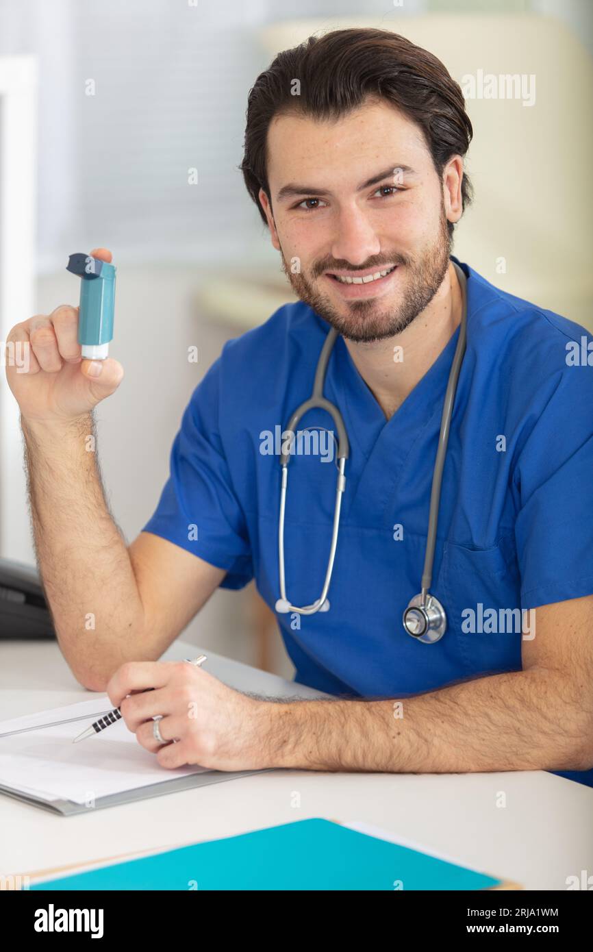 handsome male doctor holding asthma inhaler Stock Photo - Alamy