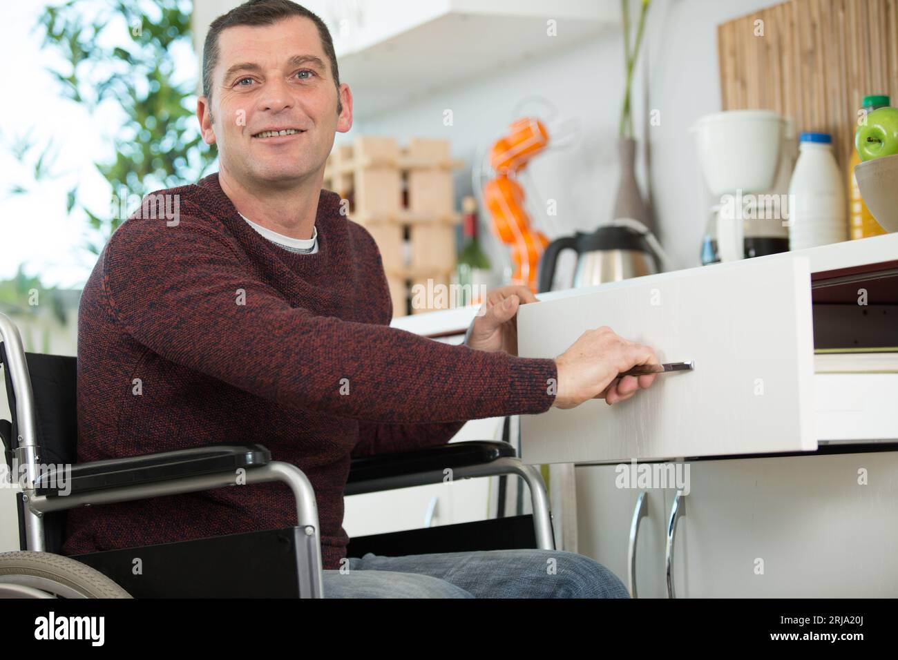disabled man on wheelchair washing dishes in the kitchen Stock Photo ...
