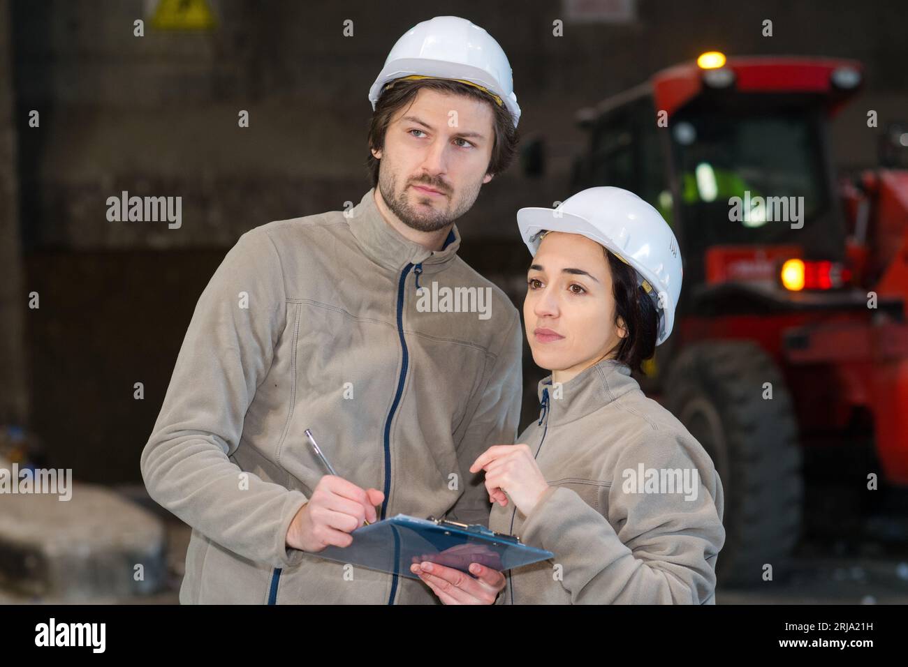 2 warehouse workers with clipboard Stock Photo - Alamy