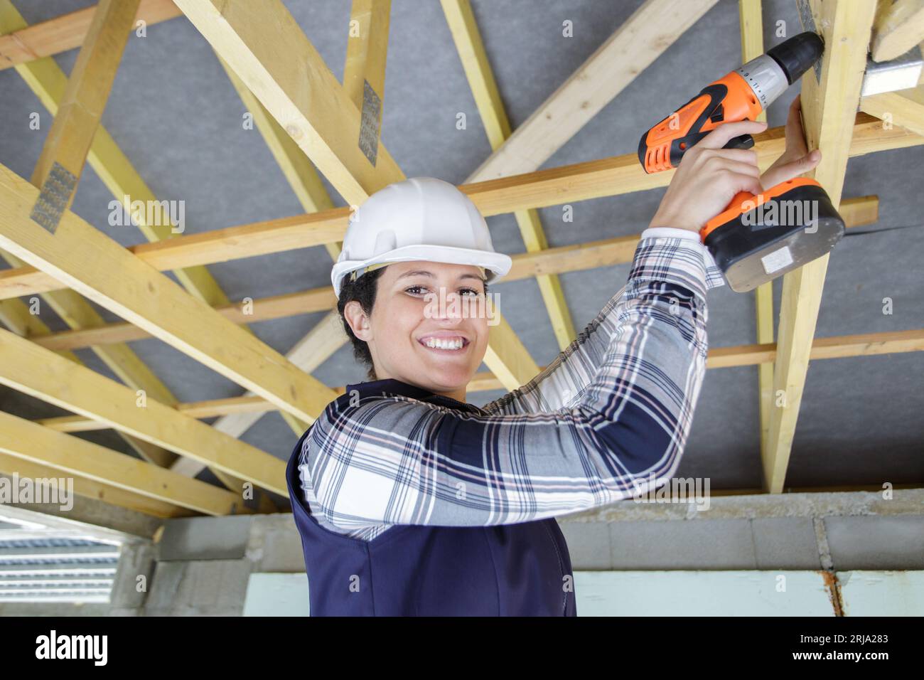 happy female worker during renovation site Stock Photo - Alamy