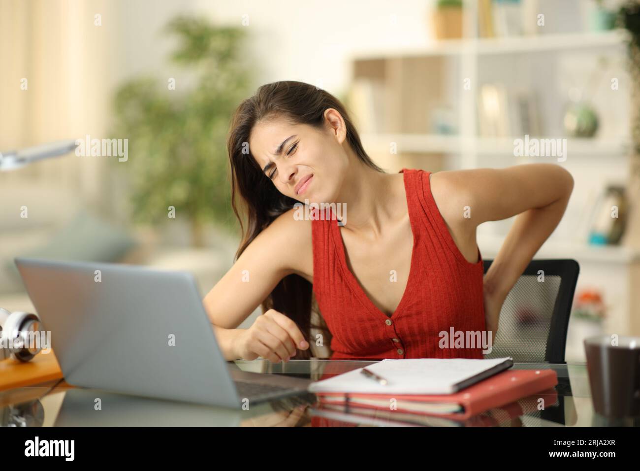 Student suffering back ache on uncomfortable chair at home Stock Photo ...