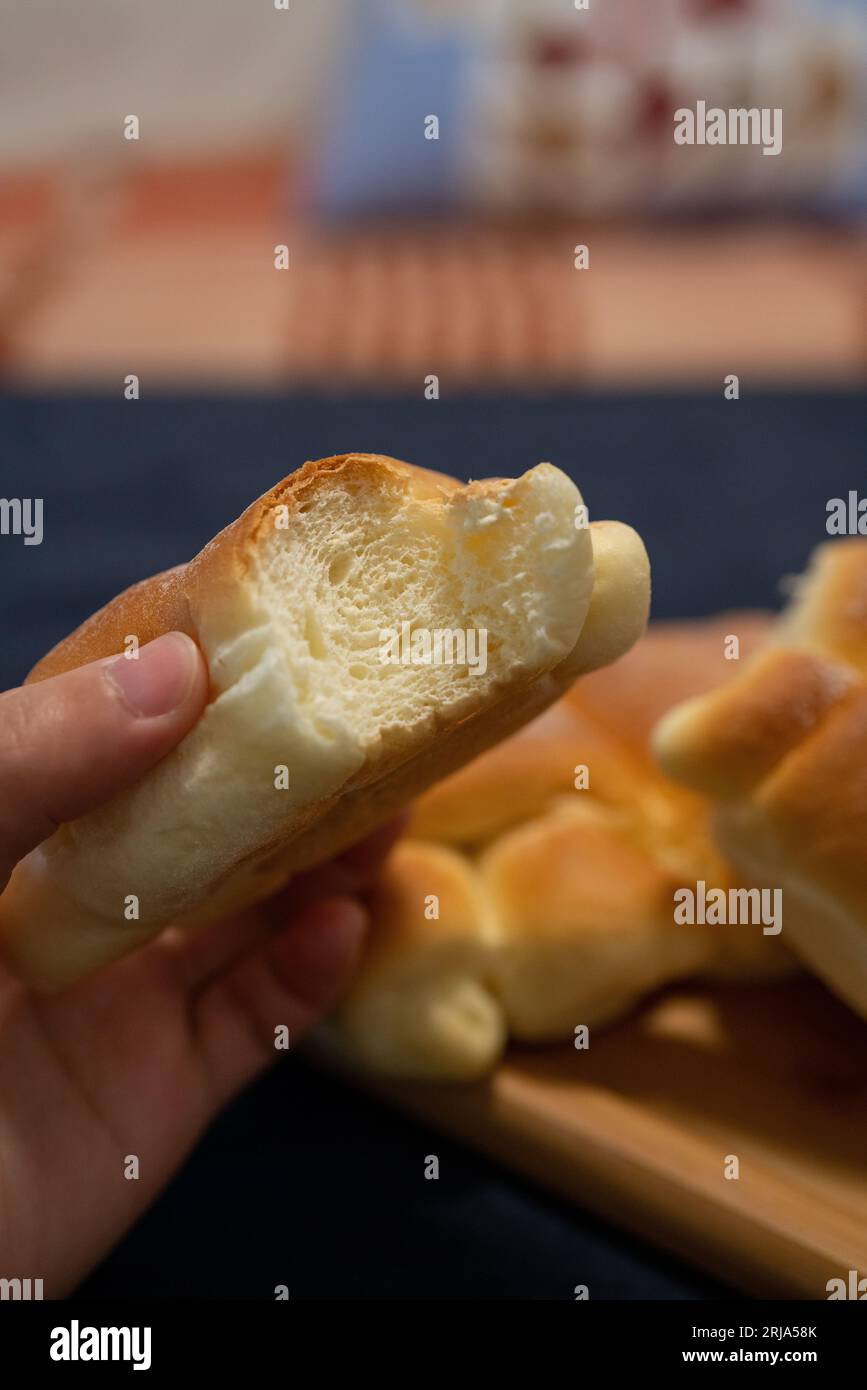 The hand is holding a bitten bread Stock Photo - Alamy