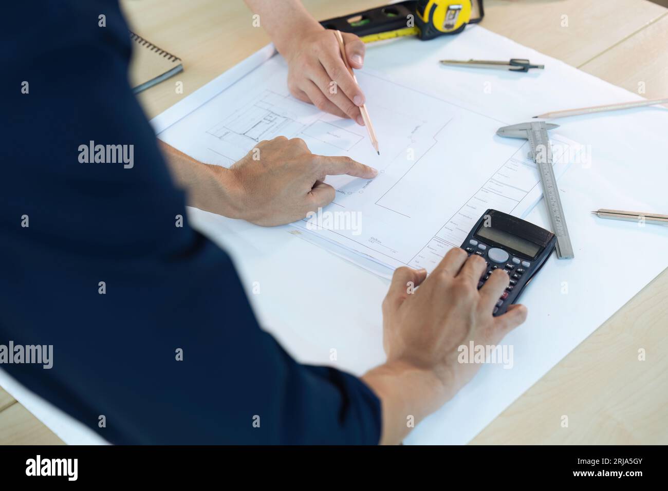 Close up of civil male engineer asian working on blueprint ...
