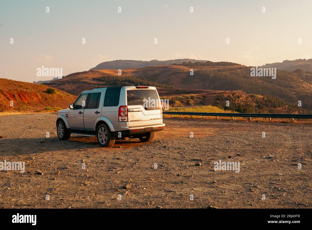 A Landrover Discovery SUV parked on a scenic view point at Sunset at ...