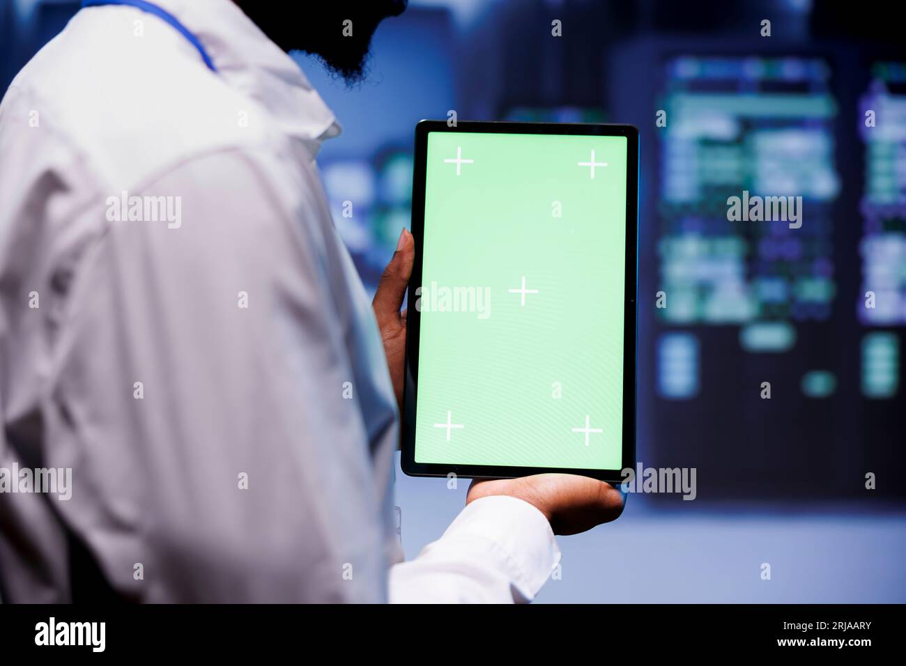 Engineer Investigating Performance Trends In Data Center Professional Using Green Screen Tablet