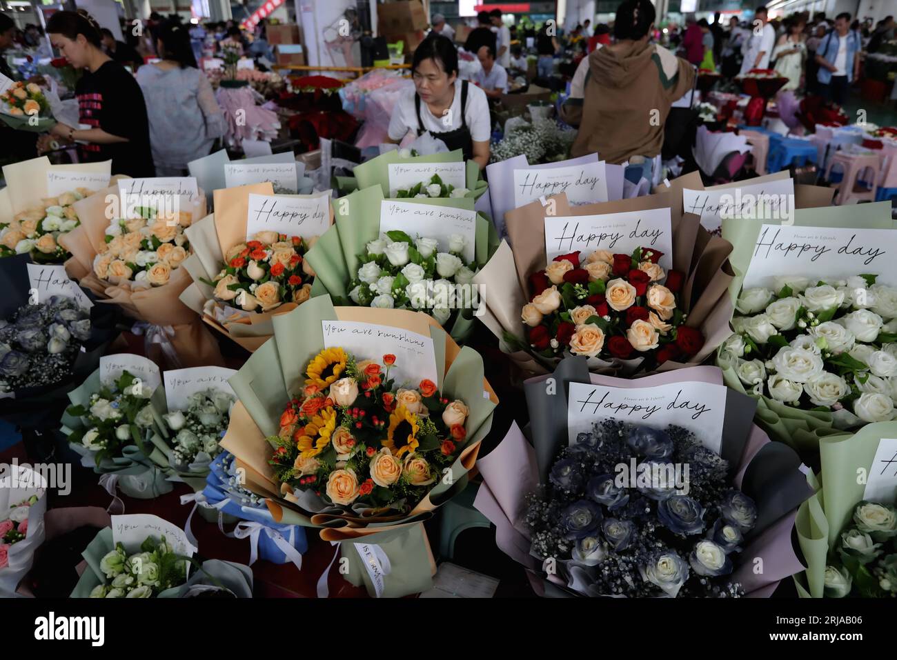 Fresh roses of various colors draw customers in Dounan flower market in ...