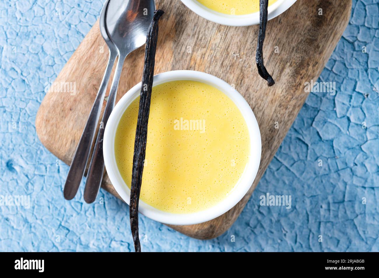 Homemade vanilla custard on blue background Stock Photo - Alamy