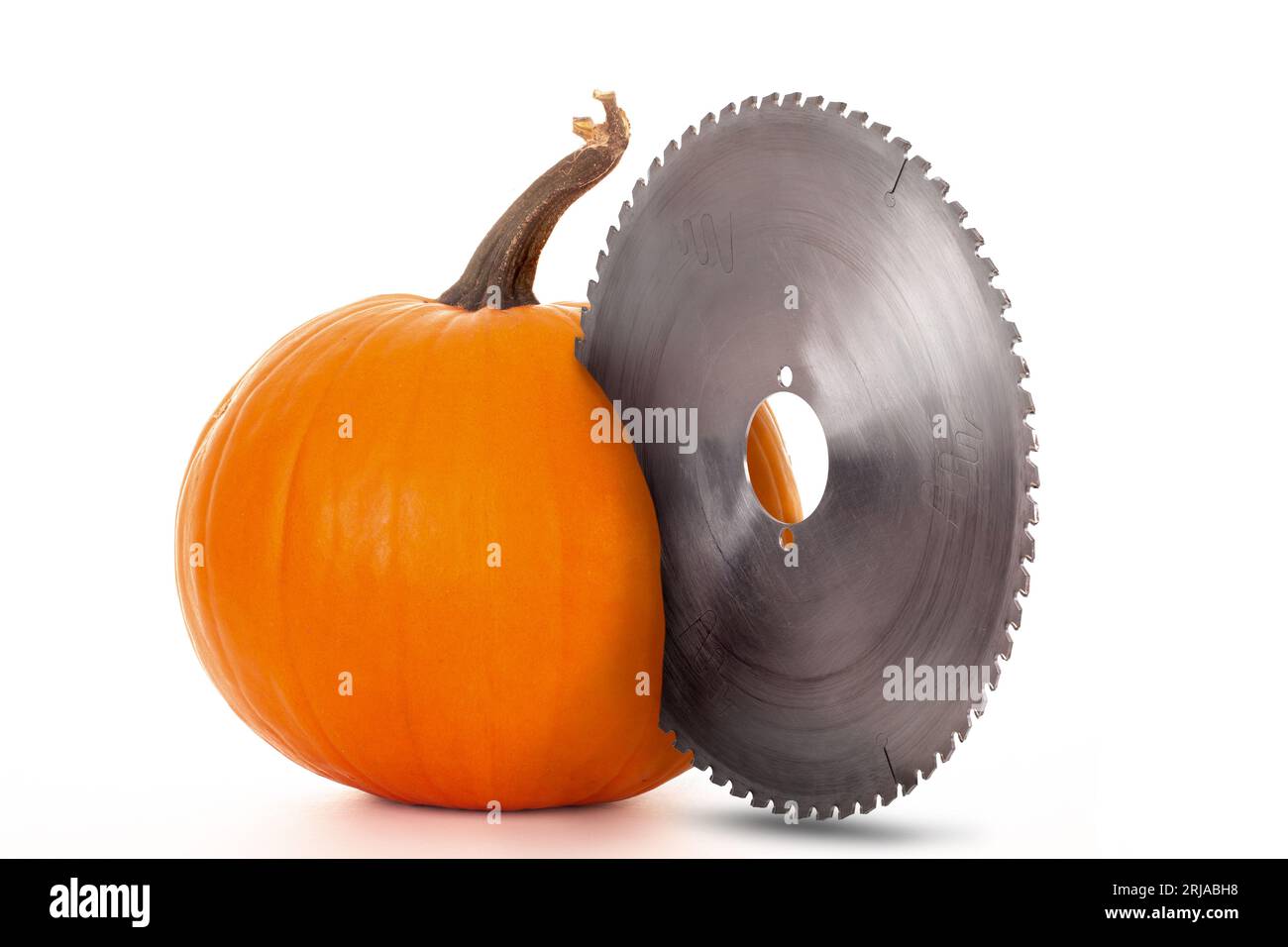 Pumpkin carving concept with a large circular saw blade cutting the ...
