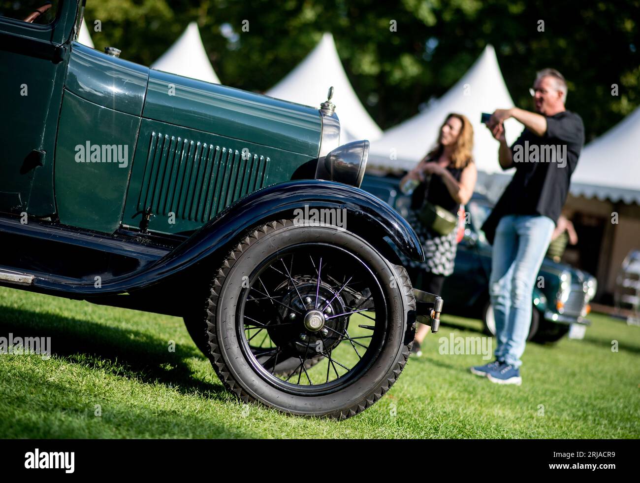 Rastede, Germany. 20th Aug, 2023. Visitors look at a historic Ford ...