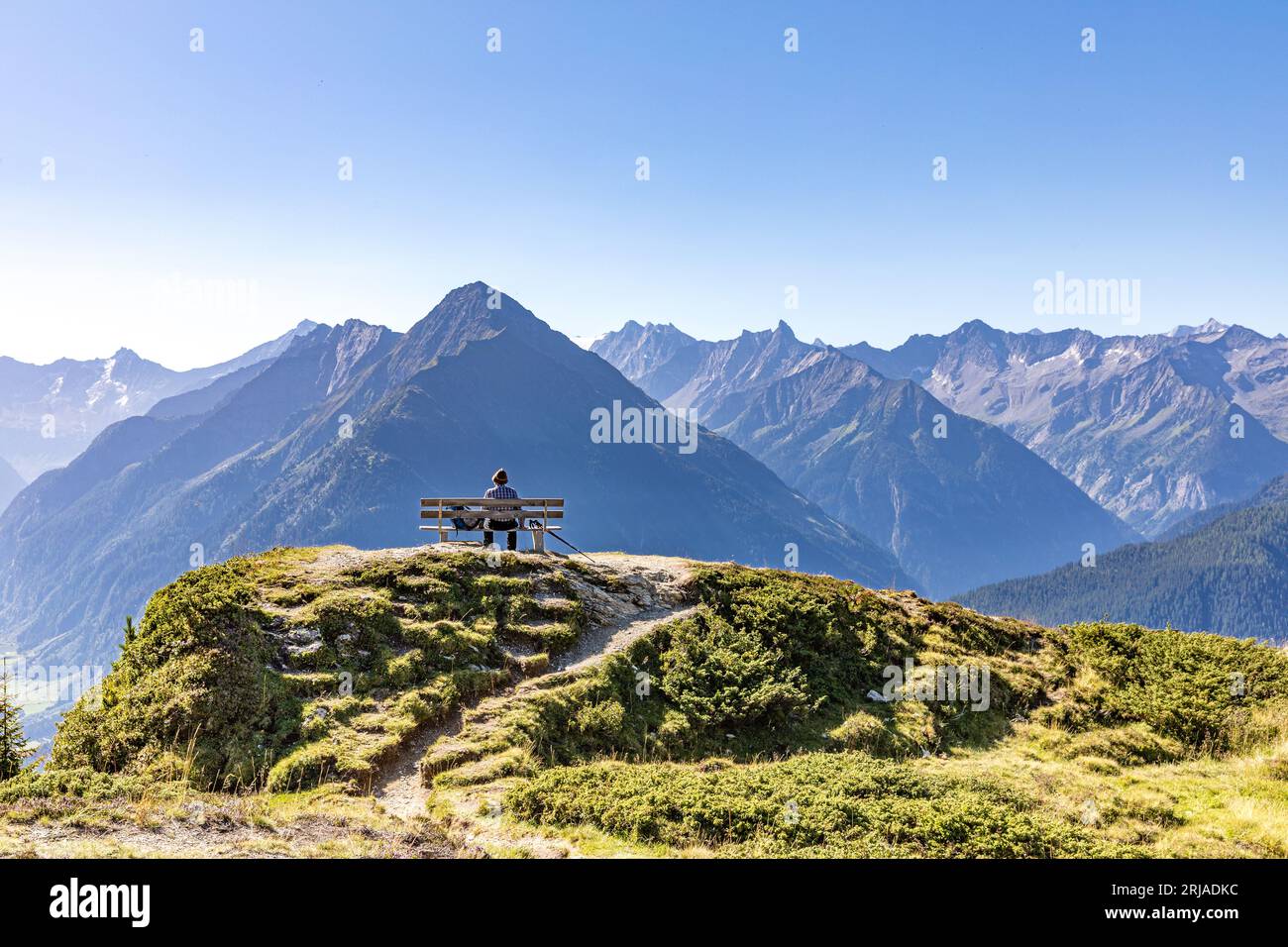 Finkenberg, Austria. 21st Aug, 2023. A hiker sits on a bench on Mount ...