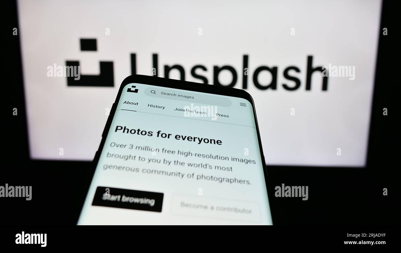 Mobile phone with website of stock photography company Unsplash Inc. on ...