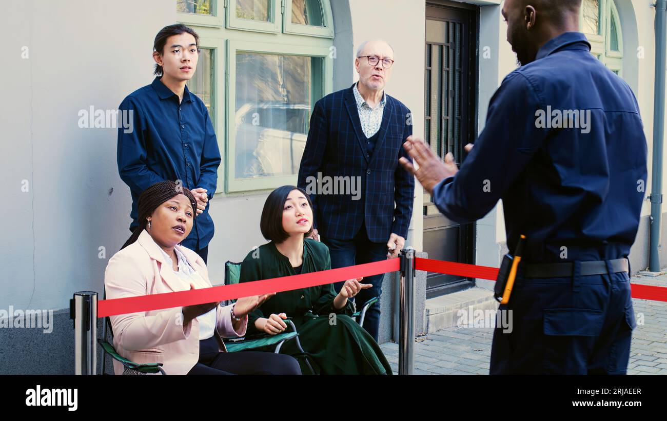 Bargain seeking clients waiting outside shopping mall entrance opening ...