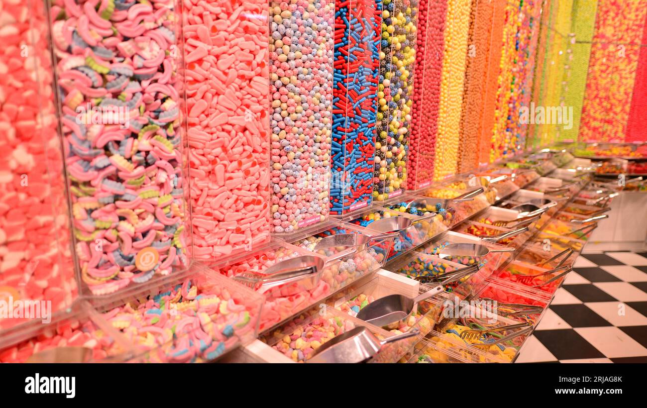 Plastic jars filled with colourful candy in shop Stock Photo - Alamy