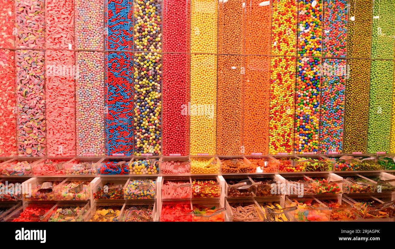 Plastic jars filled with colourful candy in shop Stock Photo - Alamy
