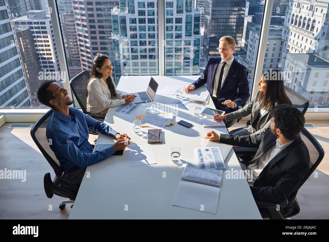 Happy busy international professional business team at group meeting ...