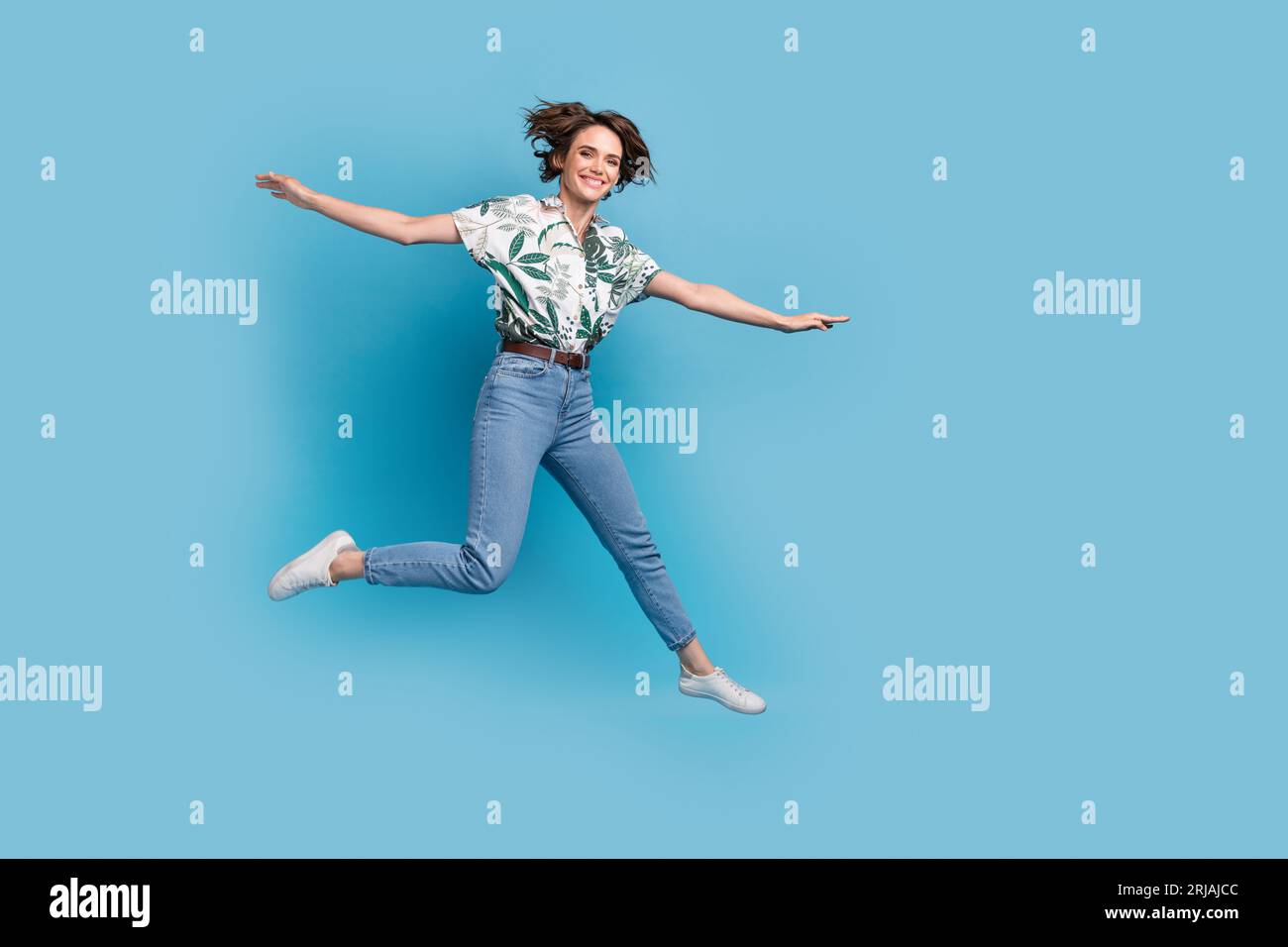 Full length photo of sweet carefree lady wear print shirt jumping high ...