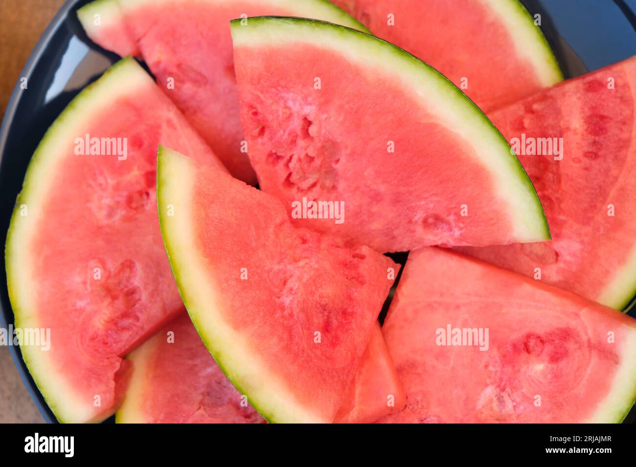 Fresh sliced red watermelon with green skin for use as a summer ...
