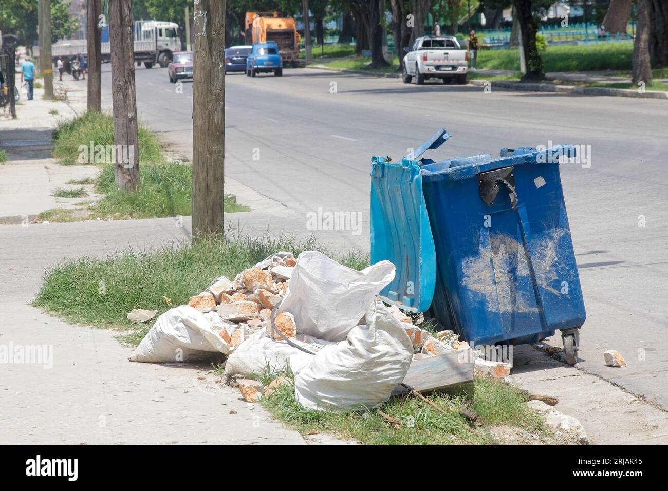Havana, Cuba, sacks of rubble discarded by large plastic garbage bins ...