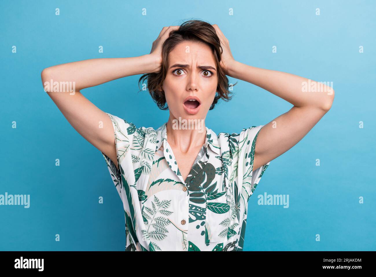 Portrait of confused frightened woman with stylish hairdo wear print ...