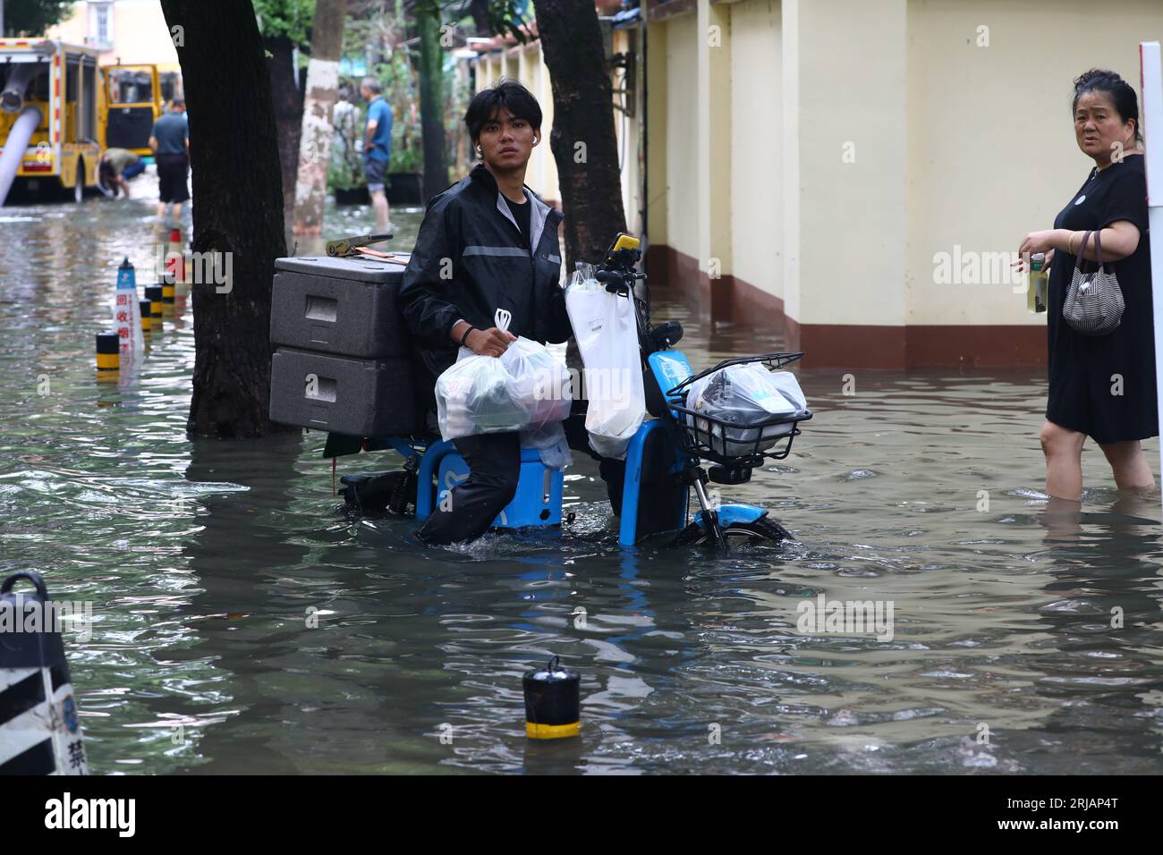 Nanjing, China. 22nd Aug, 2023. NANJING, CHINA - AUGUST 22, 2023 - A delivery man rides an ...