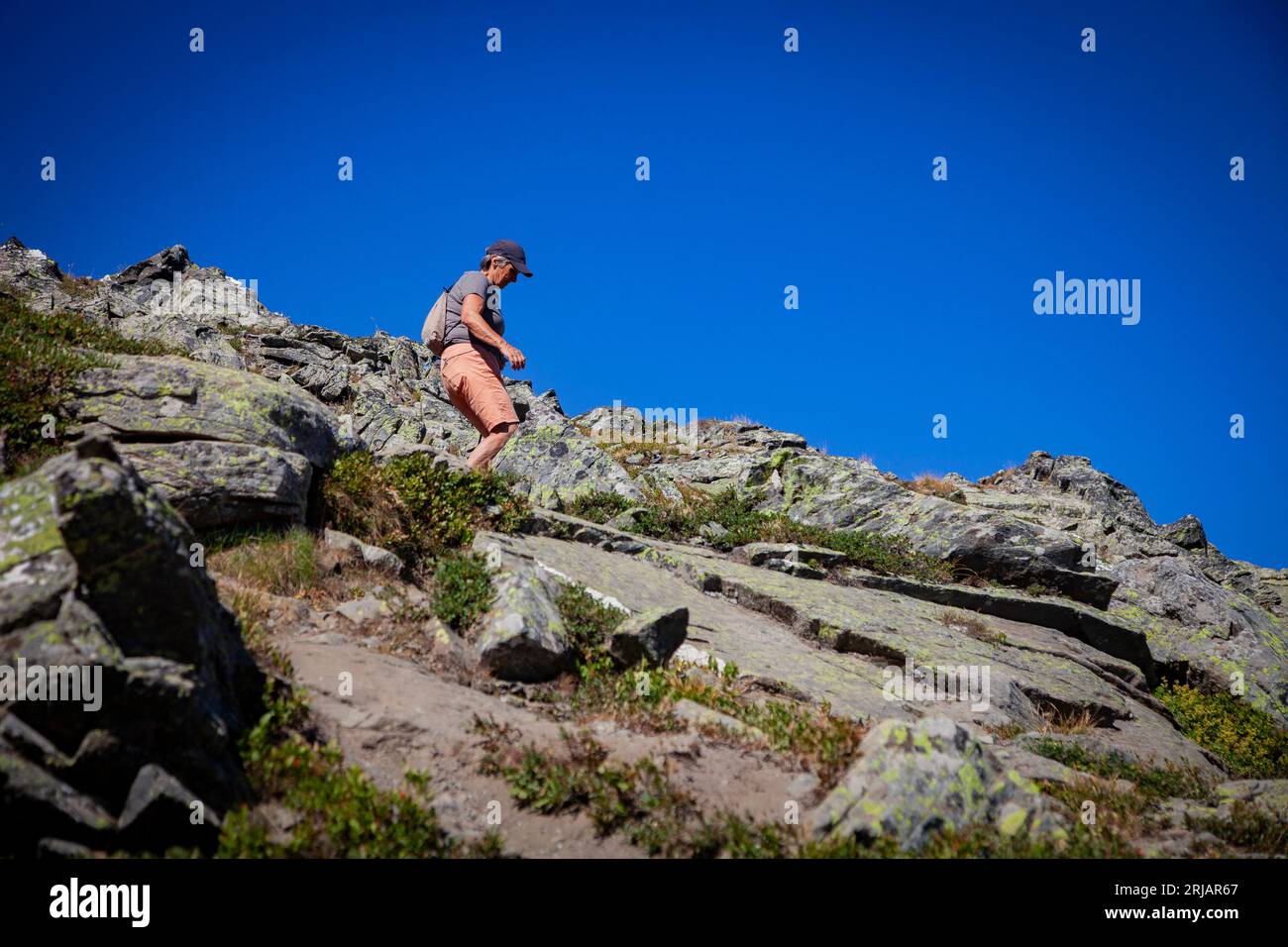 Monique 71 years old descends from the rocks towards Lake Oule, France ...