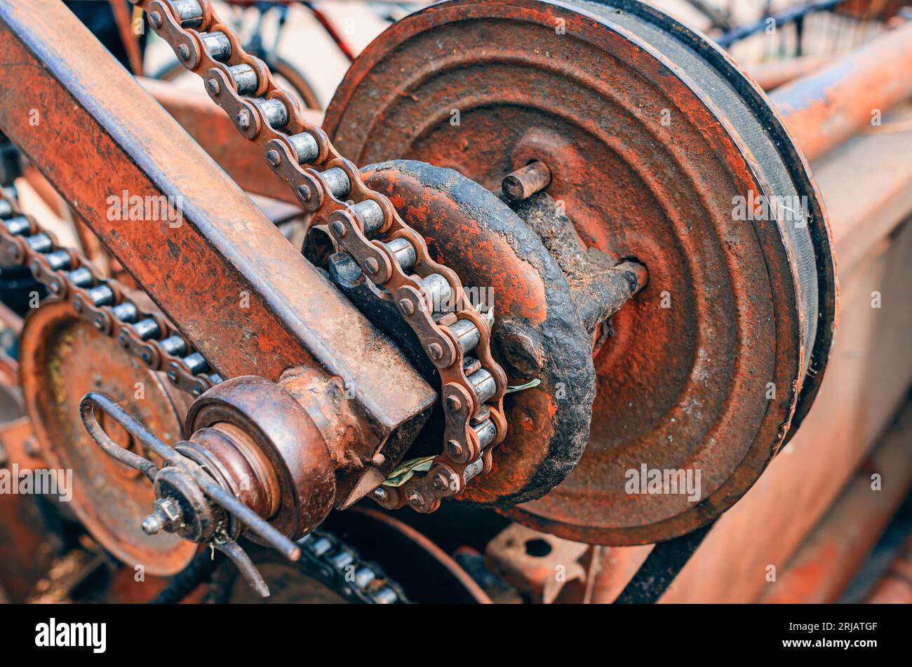 Metal chain on large gears on an old combine Stock Photo - Alamy