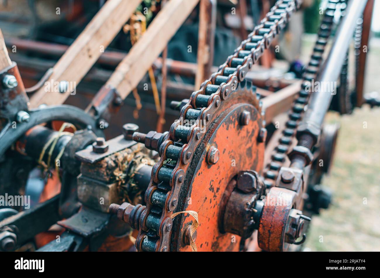 Metal chain on large gears on an old combine Stock Photo - Alamy