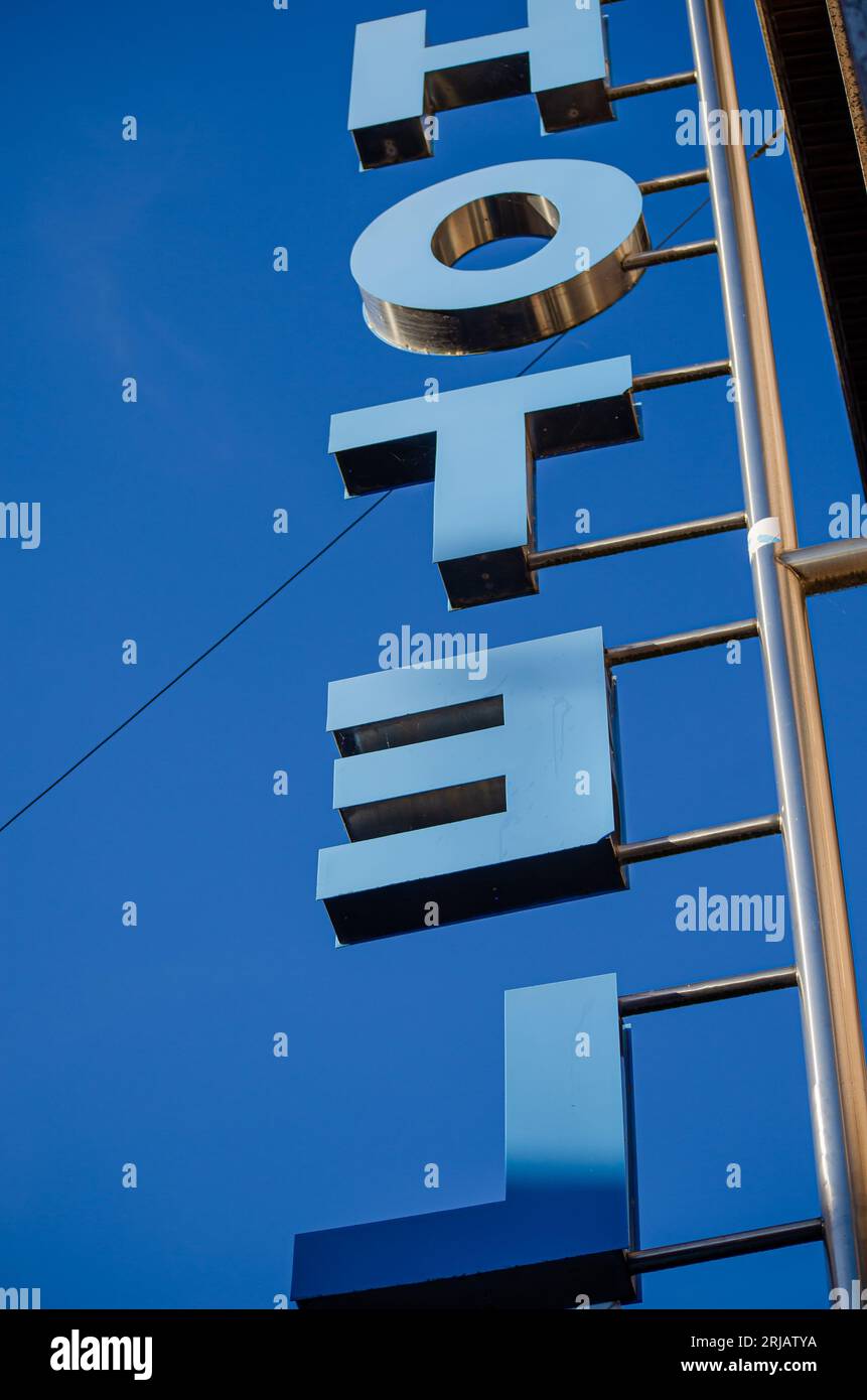 hotel sign with large blue letters Stock Photo - Alamy