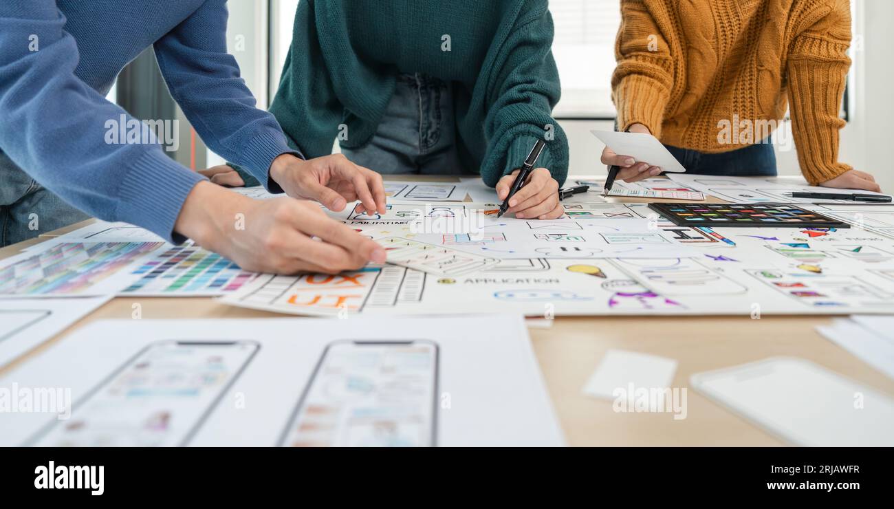 UX developer and ui designer brainstorm about mobile app interface wireframe design with ...