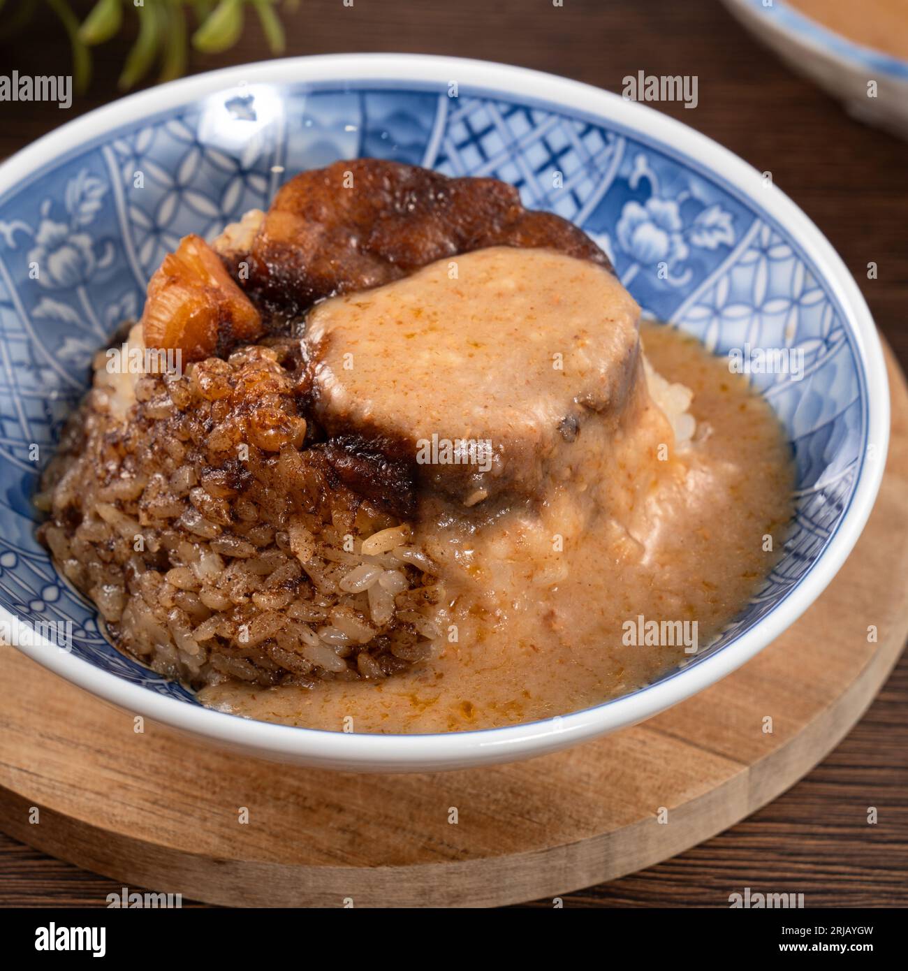 Migao, tube rice cake, rice pudding in a bowl topped with minced pork ...