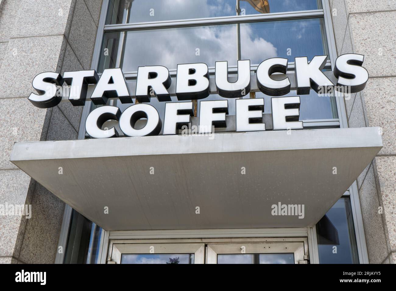 Sign Starbucks Coffee on the Europe street. Entrance in coffee shop ...