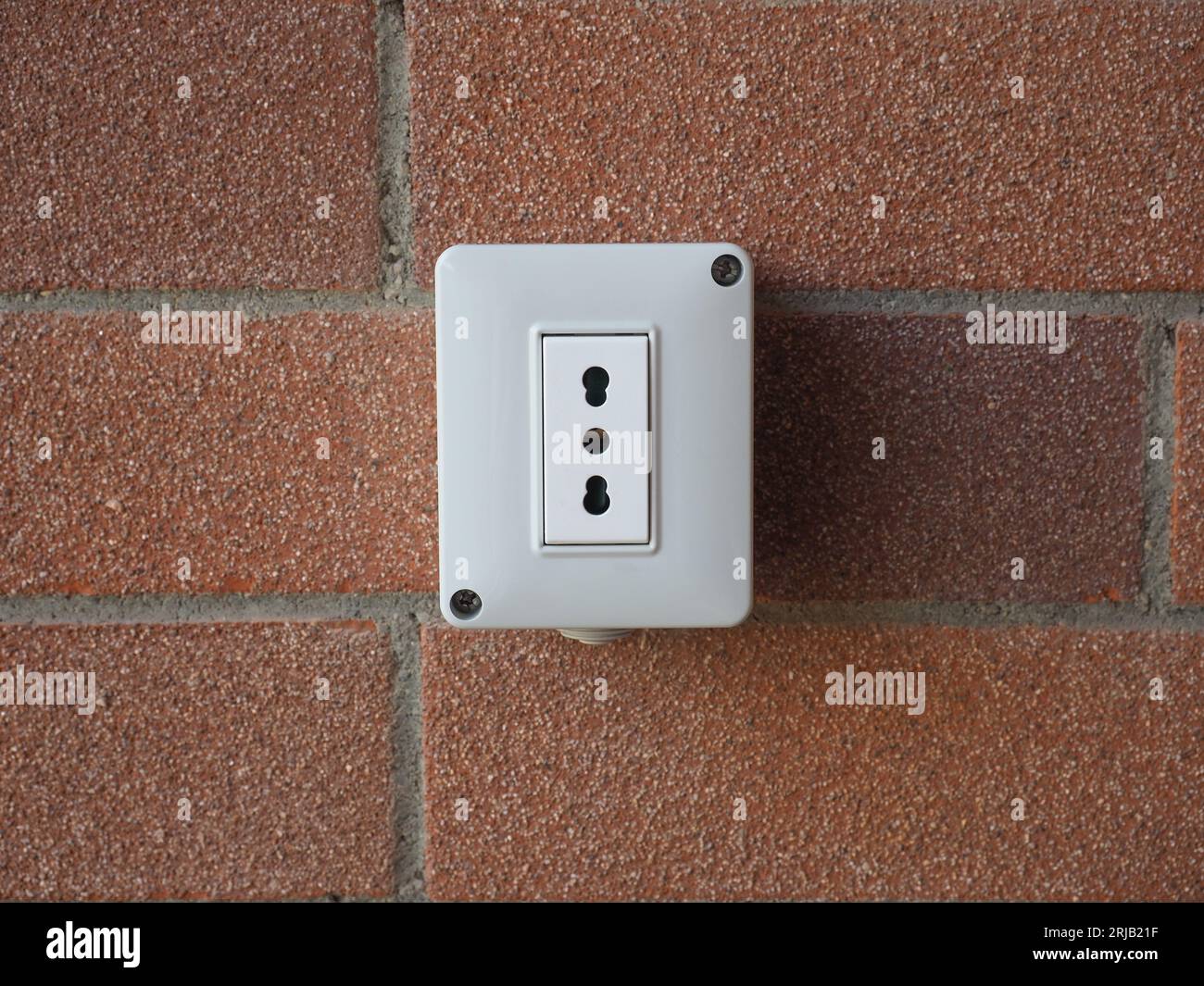 power socket over red brick wall background Stock Photo - Alamy