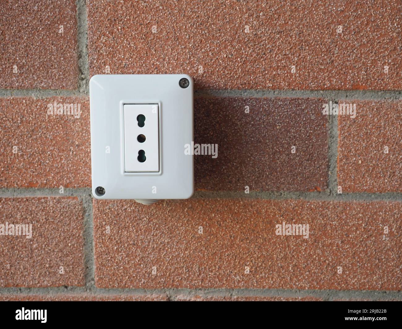 power socket over red brick wall background Stock Photo - Alamy