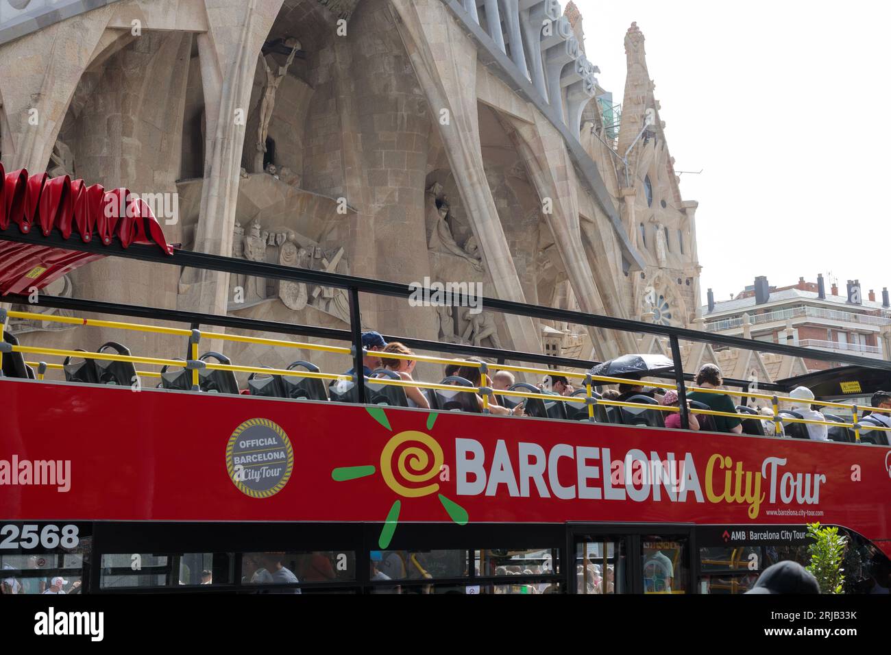 Tourists on a sightseeing bus in Barcelona with the iconic Sagrada ...