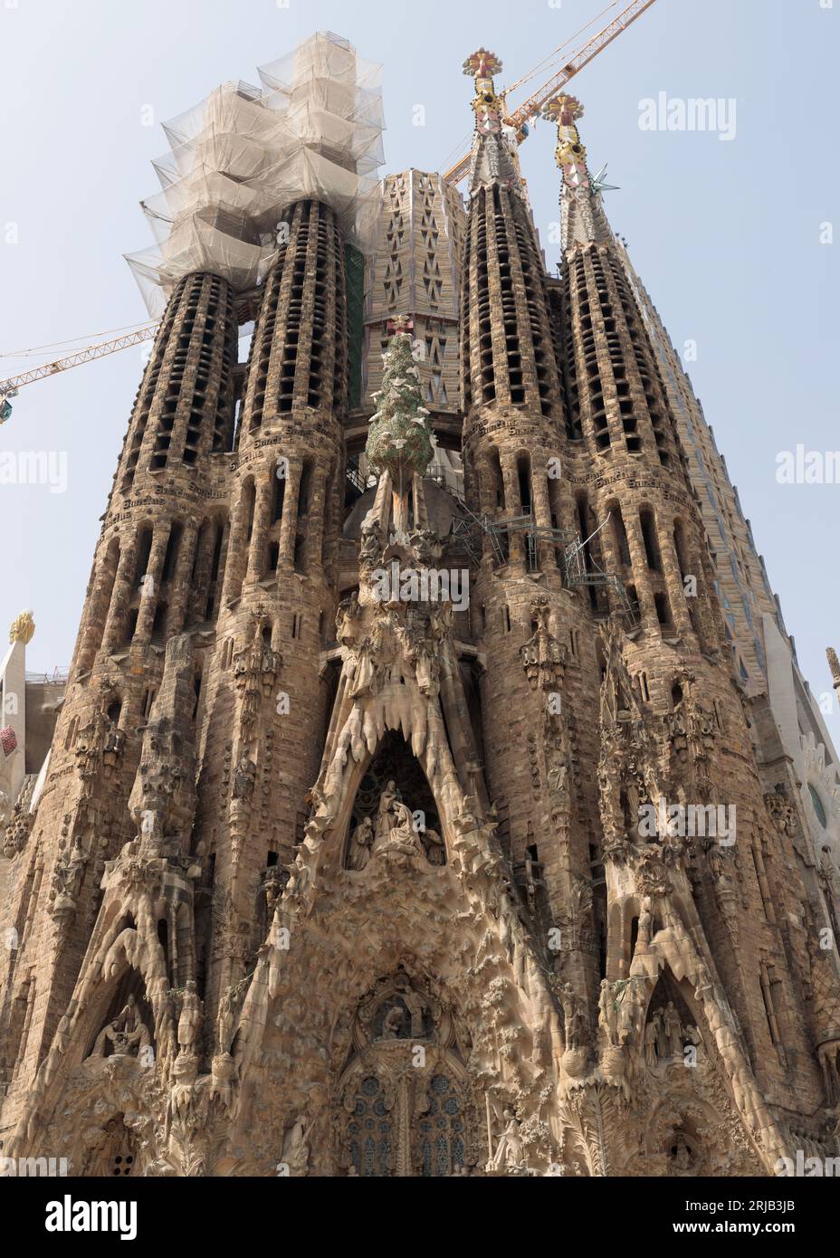 A view showing the intricate details of the facade of La Sagrada Familia, the iconic cathedral ...