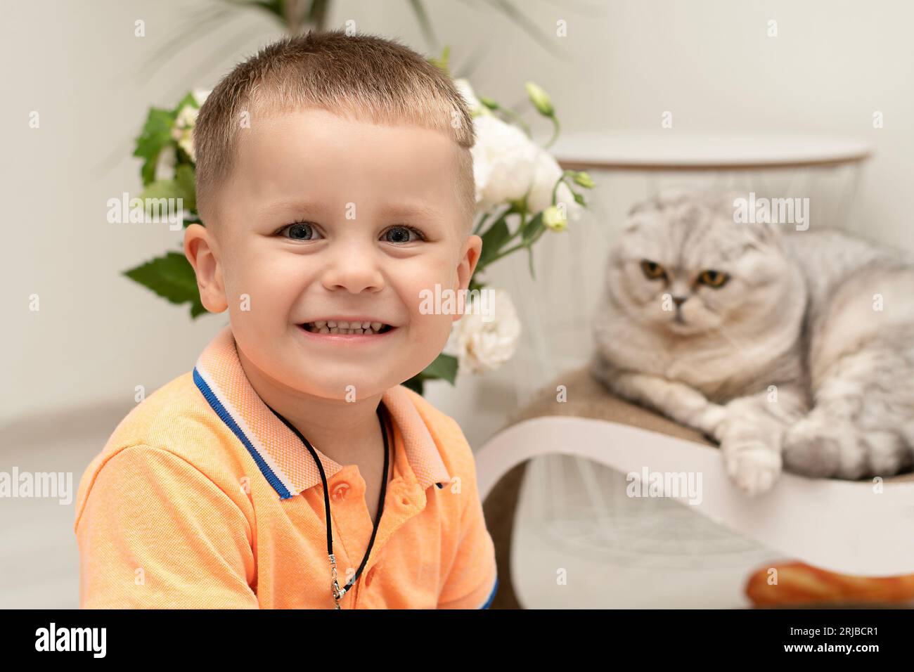 Portrait of a beautiful boy. The child looks into the frame, next to it ...