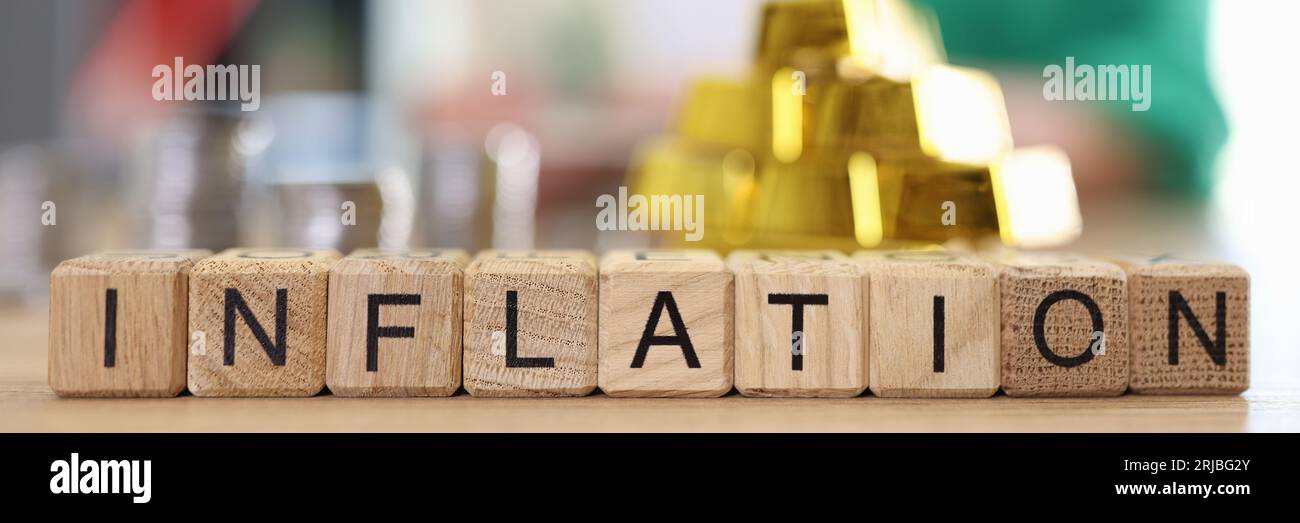 Word inflation collected from wooden cubes with gold bars and stacks of ...