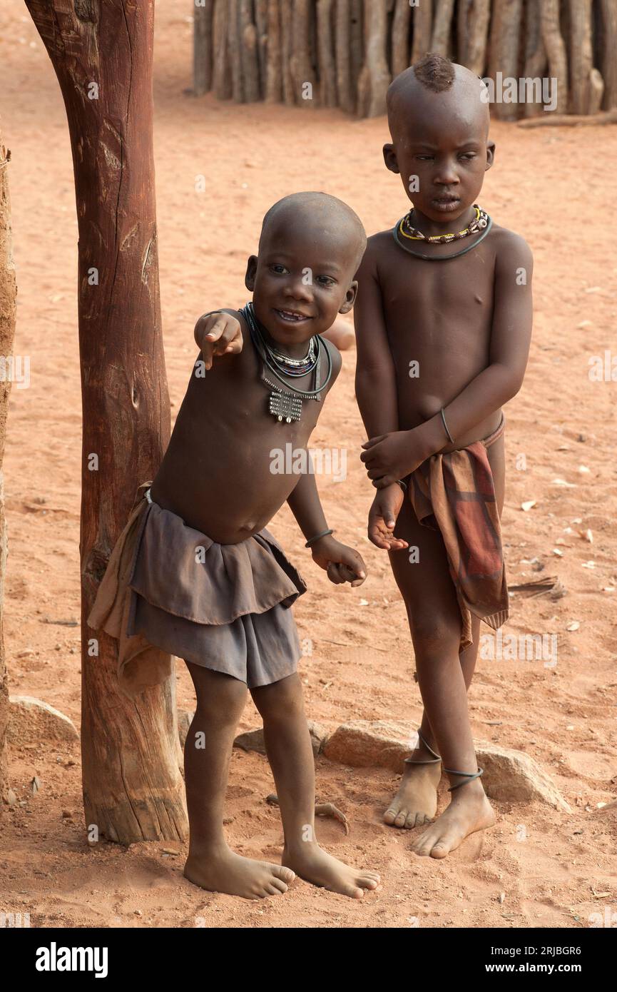 Himba childrens in front of his hut. Epupa, Kunene Region, Kaokoland ...