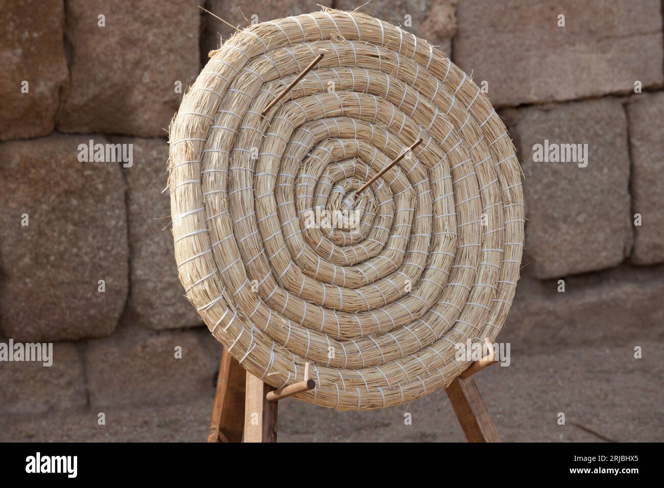 Ancient coiled straw target over wooden stand. Atreial material used by ...