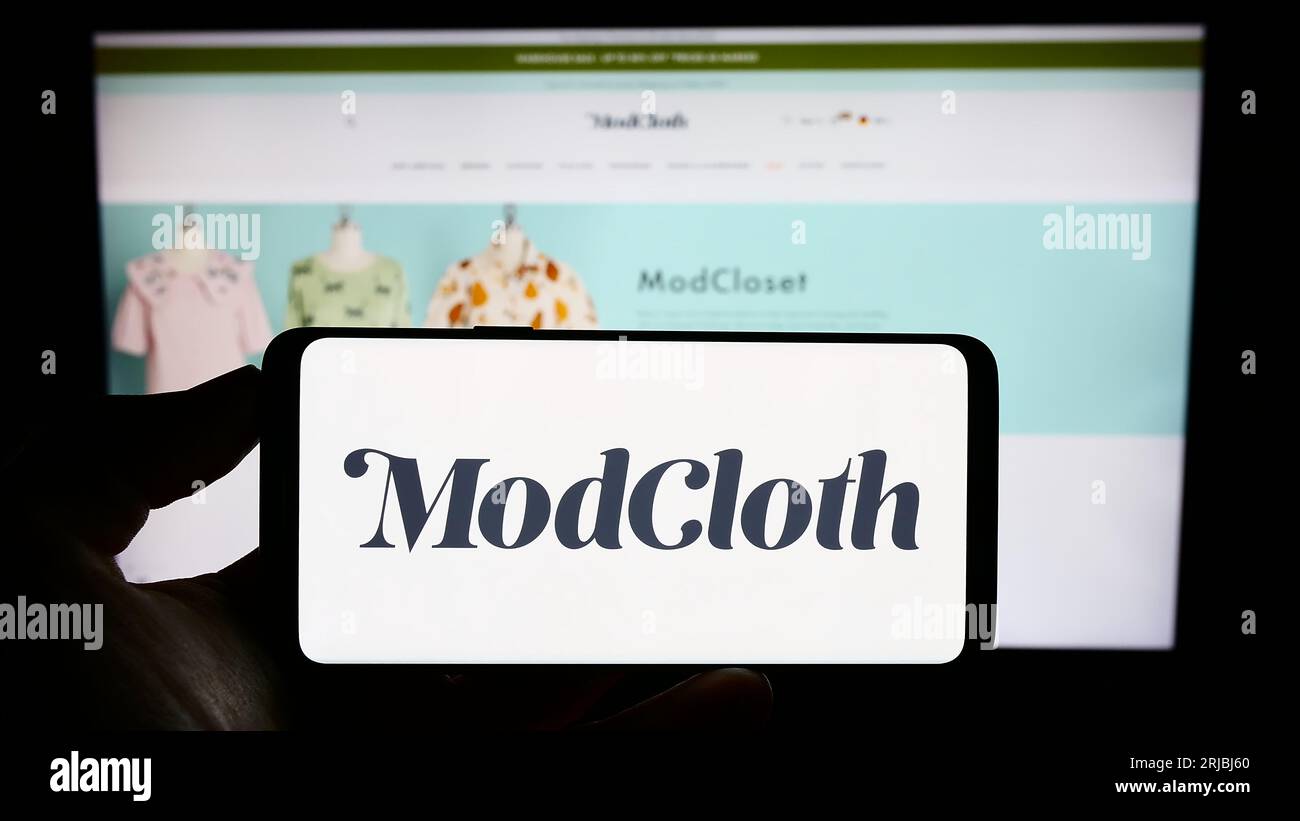 Person holding cellphone with logo of US e-commerce company ModCloth on ...
