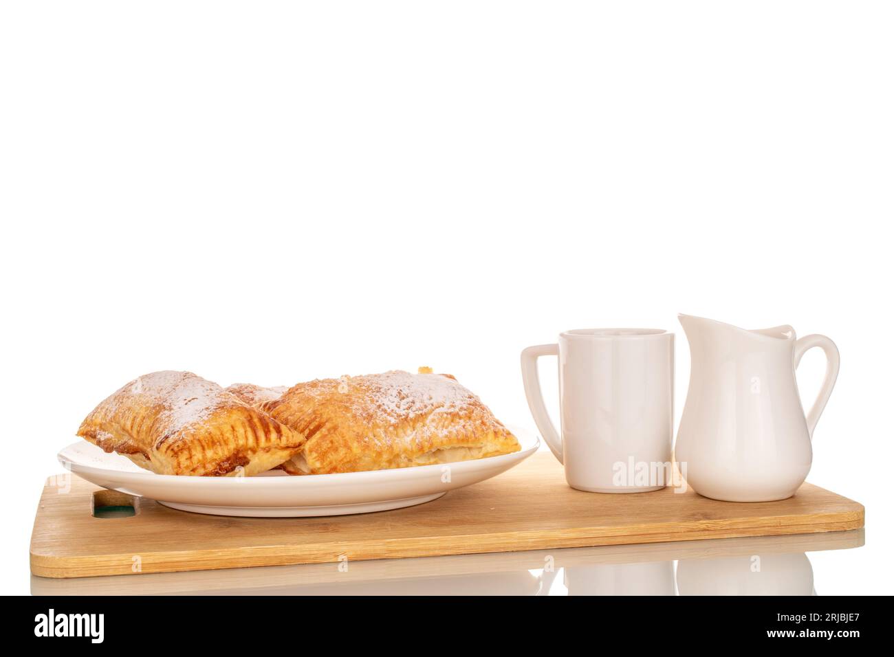 Three aromatic puff pastry buns with apples on a white ceramic plate ...