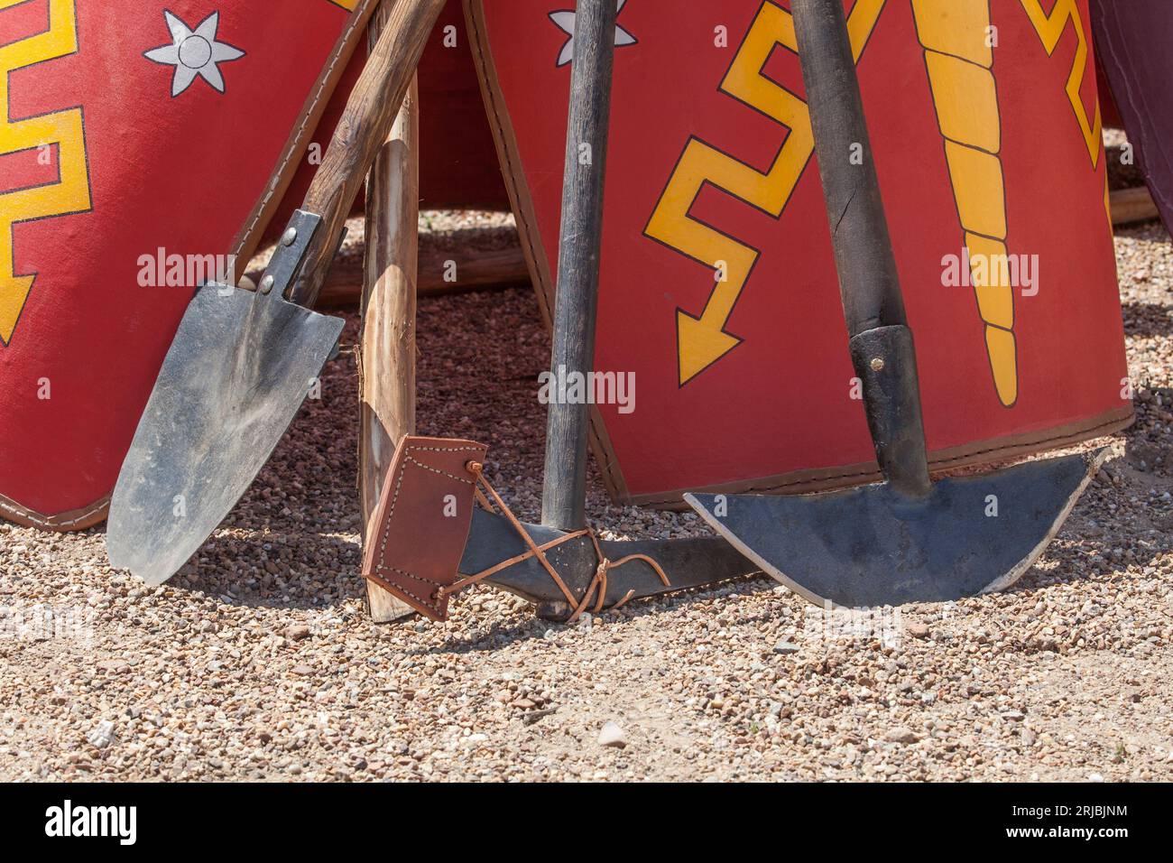 Entrenching tools supported in shields. Digging tools used by ancient ...