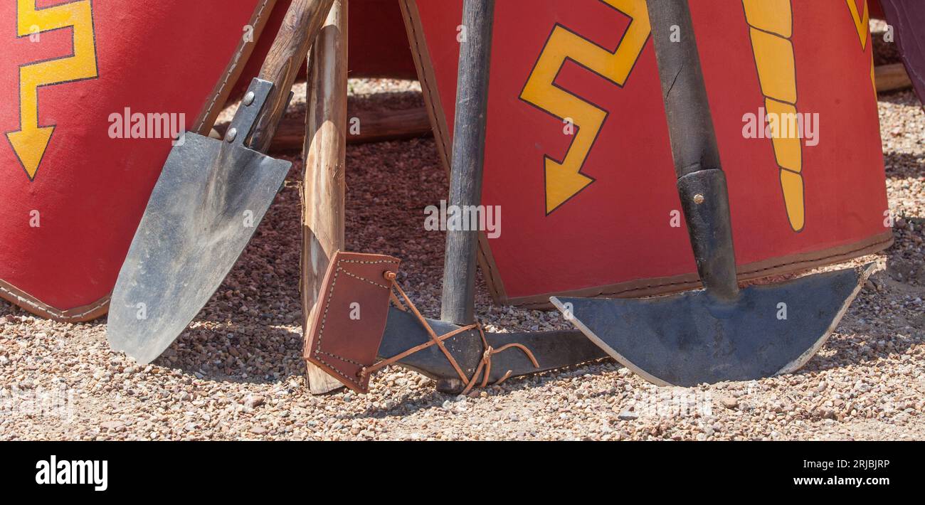 Entrenching tools supported in shields. Digging tools used by ancient ...