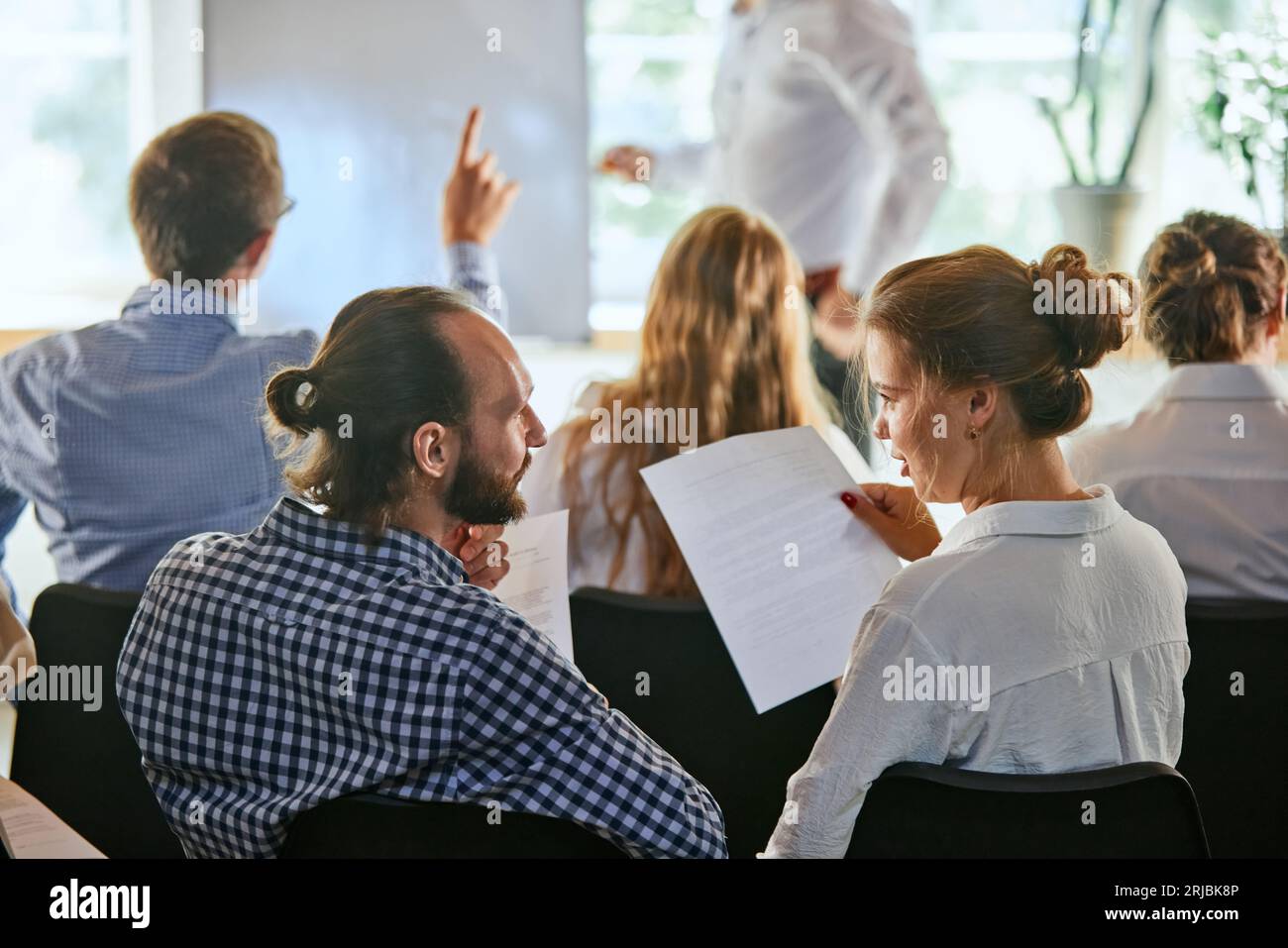 Male speaker giving talk at business meeting. Rear view of business ...