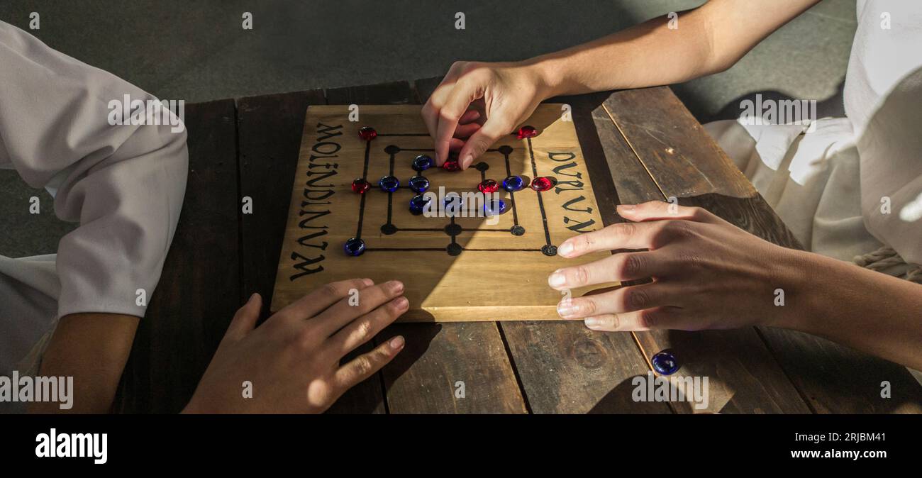 Reenactors playing molendinum, ancient roman board game Stock Photo - Alamy