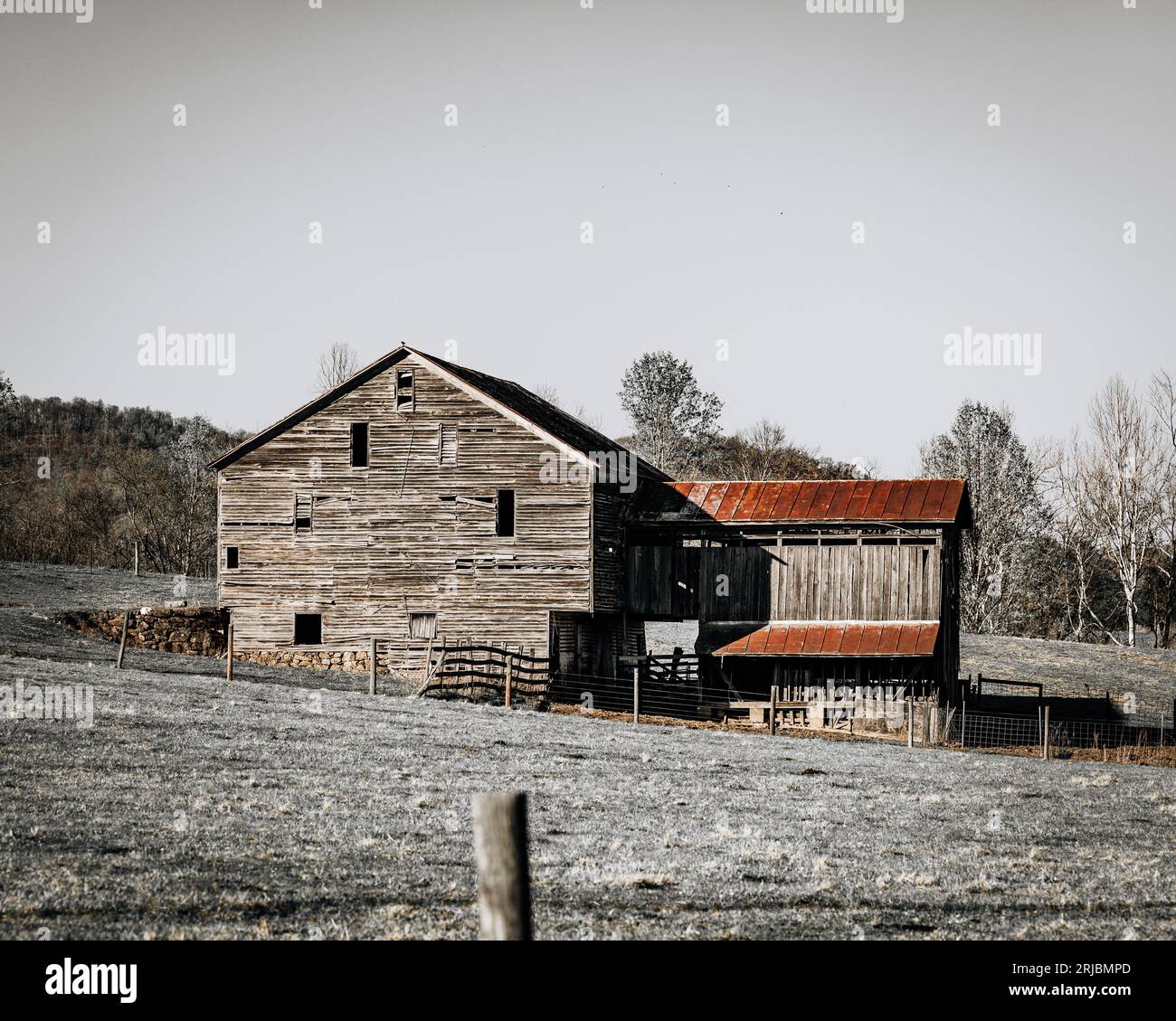 An old wooden farmhouse in a peaceful rural landscape, surrounded by ...