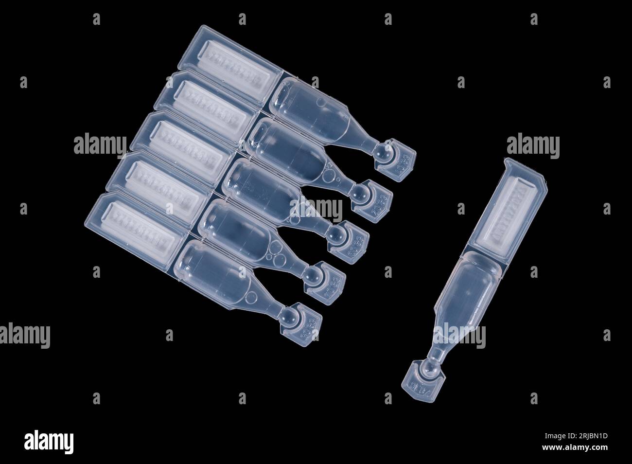 Disposable eye drops isolated on black background Stock Photo - Alamy